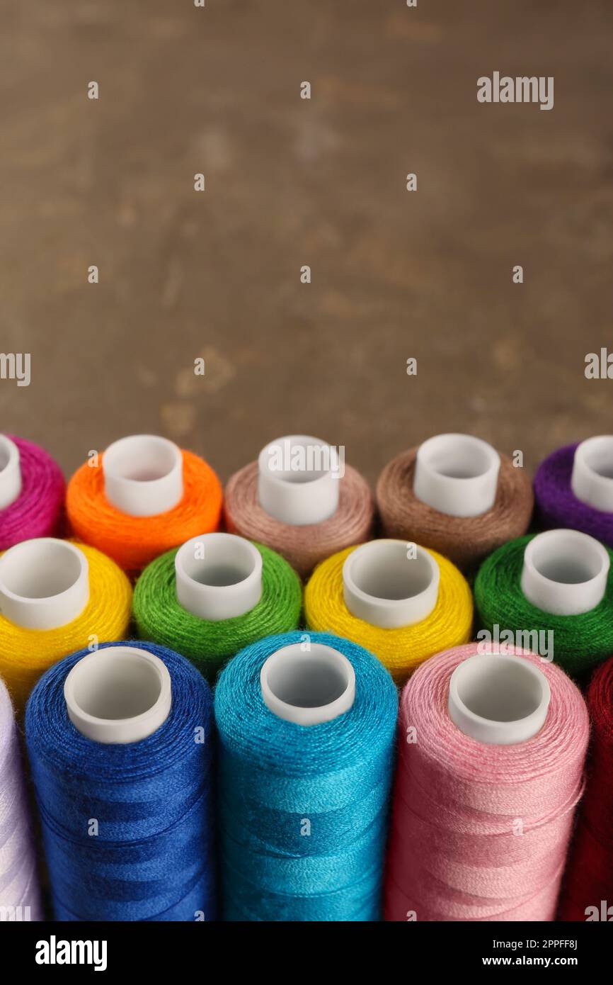Set of color sewing threads on grey table Stock Photo - Alamy