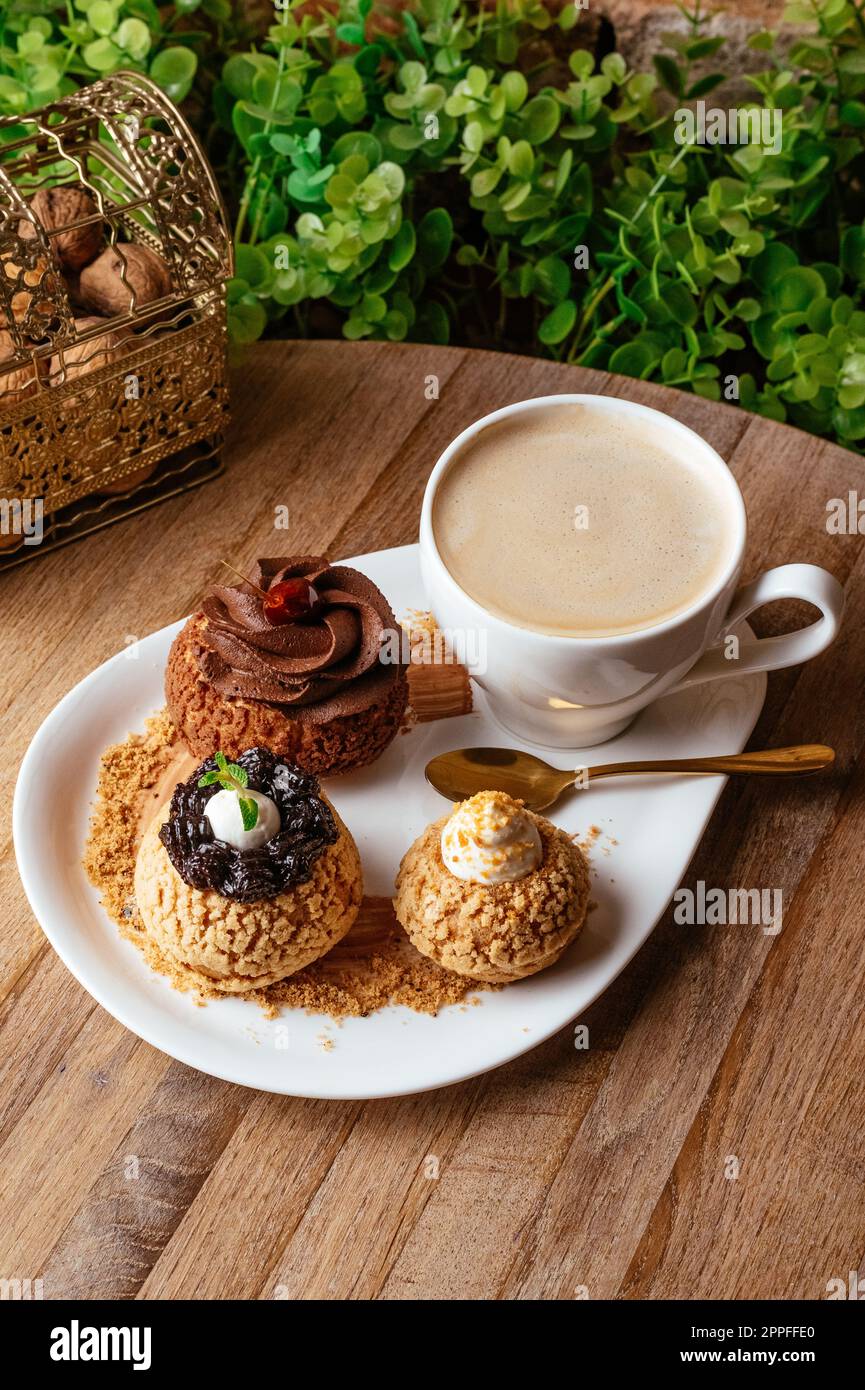 profiteroles and coffee in a cup Stock Photo - Alamy