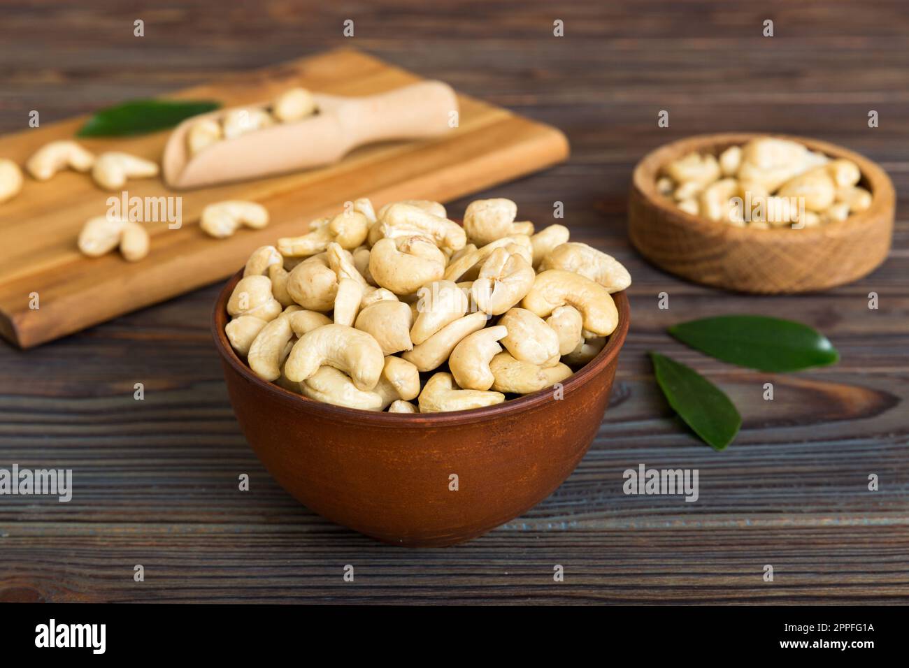 cashew nuts in wooden bowl on table background. top view. Space for ...