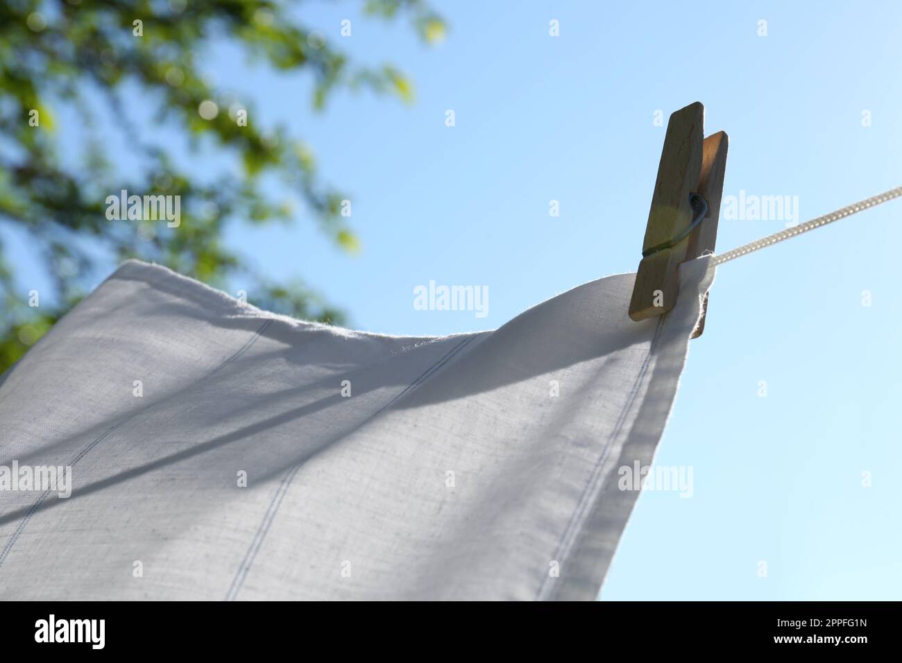 Washing line with clean laundry and clothespin outdoors, closeup Stock ...