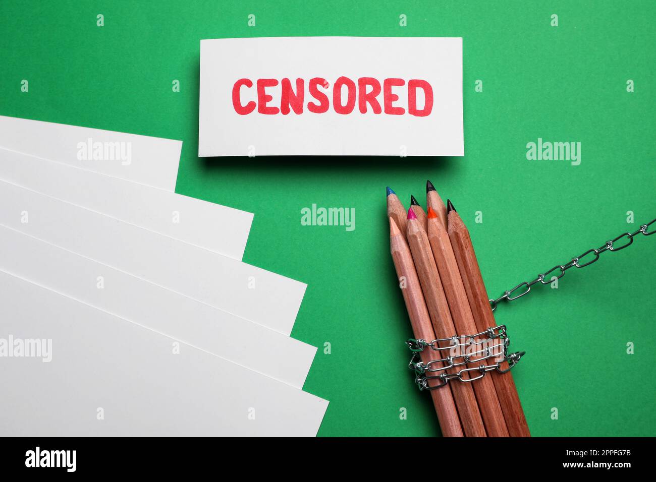 Card with word Censored, paper sheets, colorful pencils and chain on ...