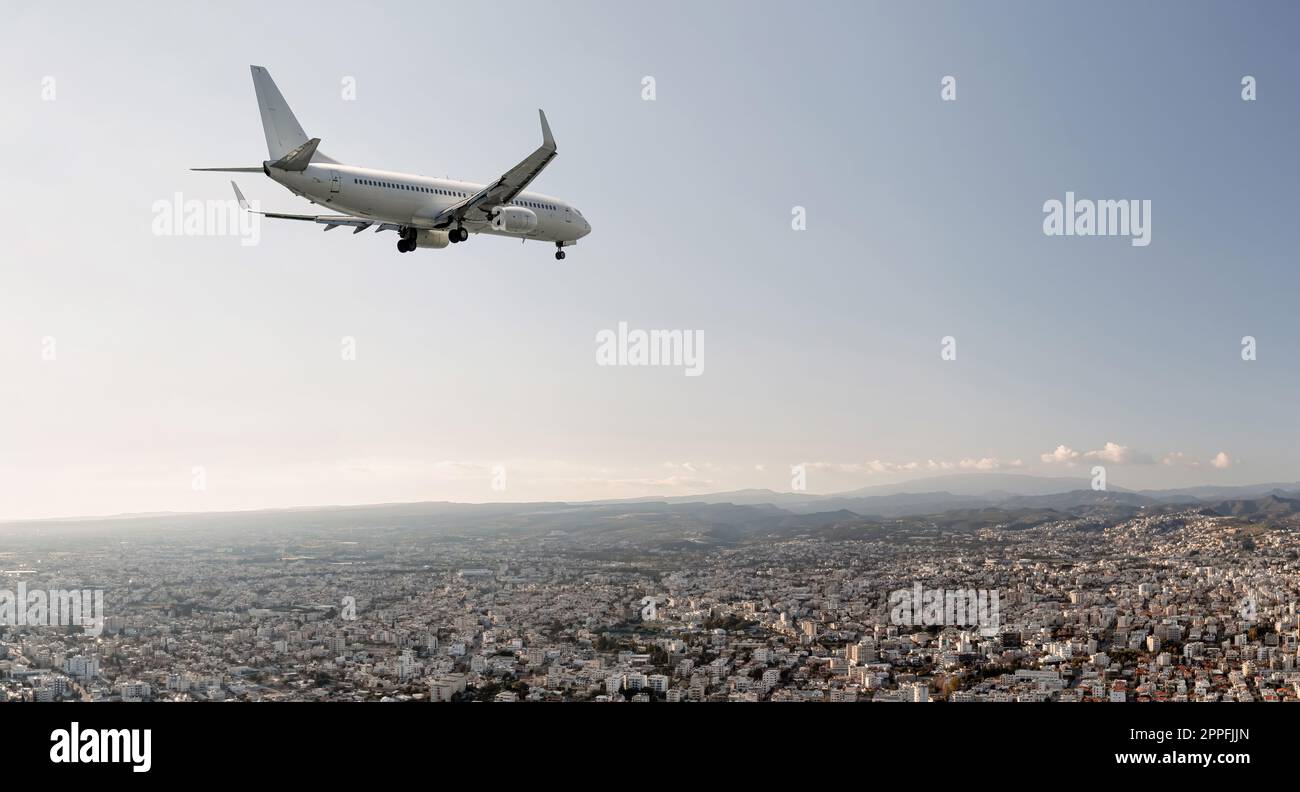 Passengers commercial airplane flying above Limassol city, Cyprus Stock ...