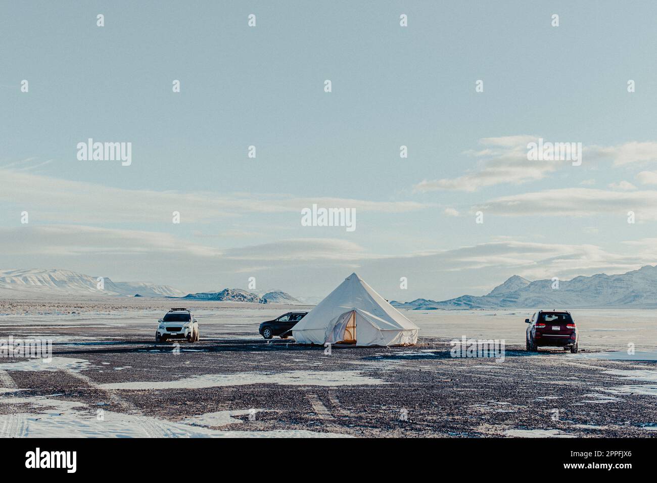 SUV's surround a tent in a barren land in winter Stock Photo - Alamy