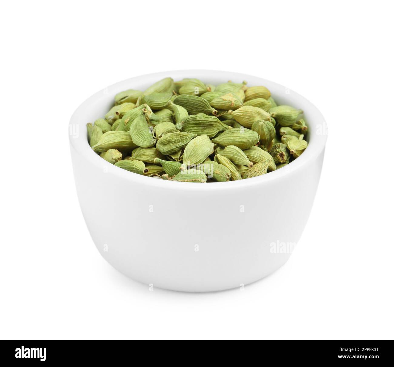 Dry cardamom pods in bowl isolated on white Stock Photo - Alamy