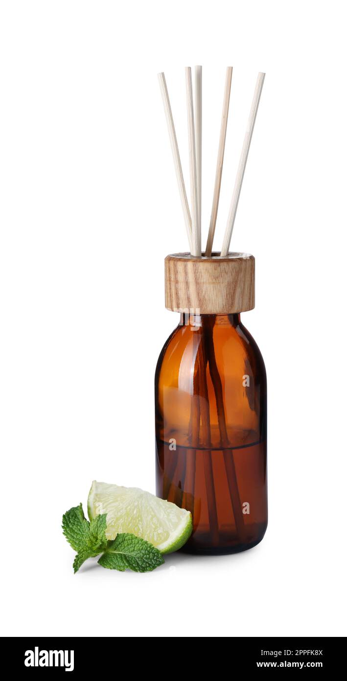 Aromatic reed air freshener with slice of lime and mint on white ...