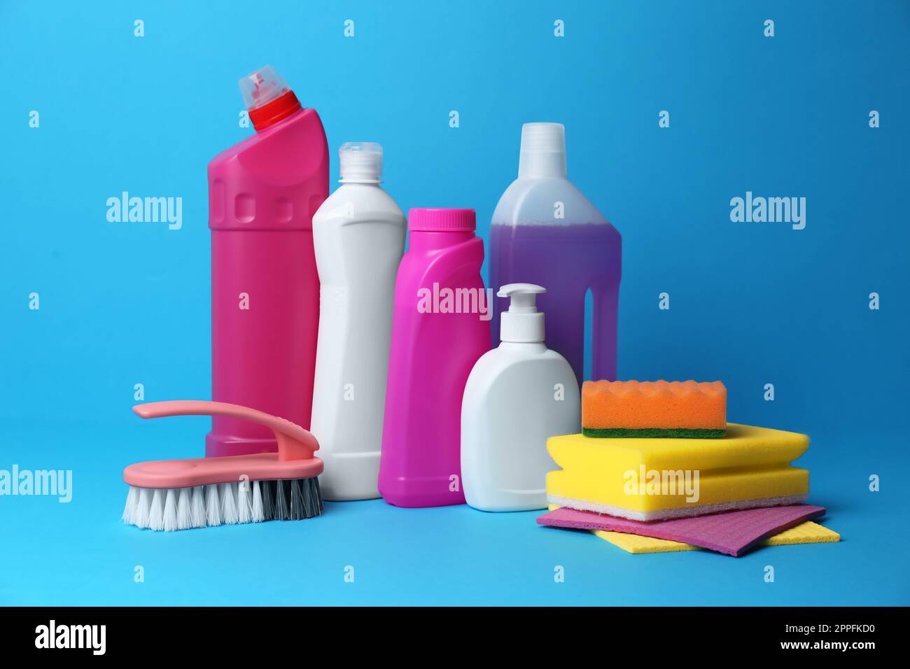 Cleaning supplies and tools on light blue background Stock Photo - Alamy
