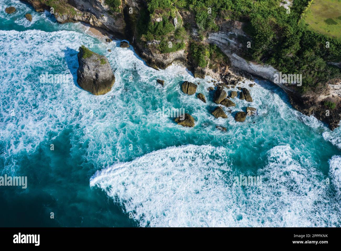 Waves breaking along the cliffs of Uluwatu in South Bali Indonesia ...