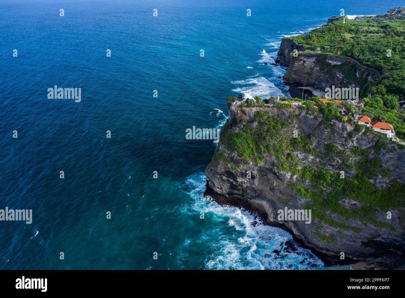 Uluwatu temple sitting on the cliff in South Bali Indonesia Stock Photo ...