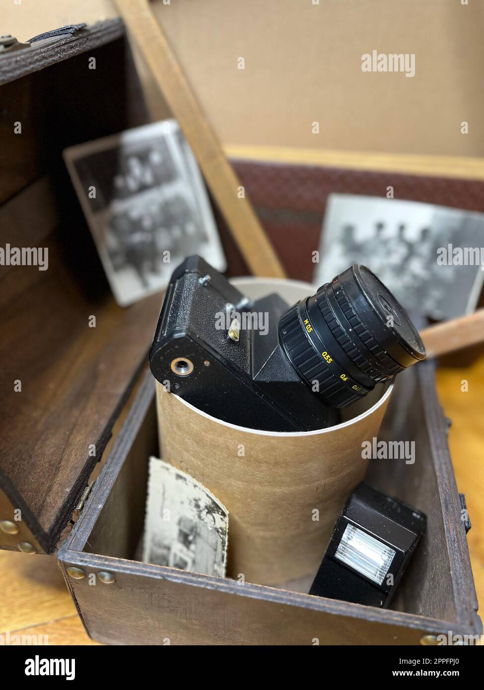 an old SLR camera in a frame and in a chest Stock Photo - Alamy