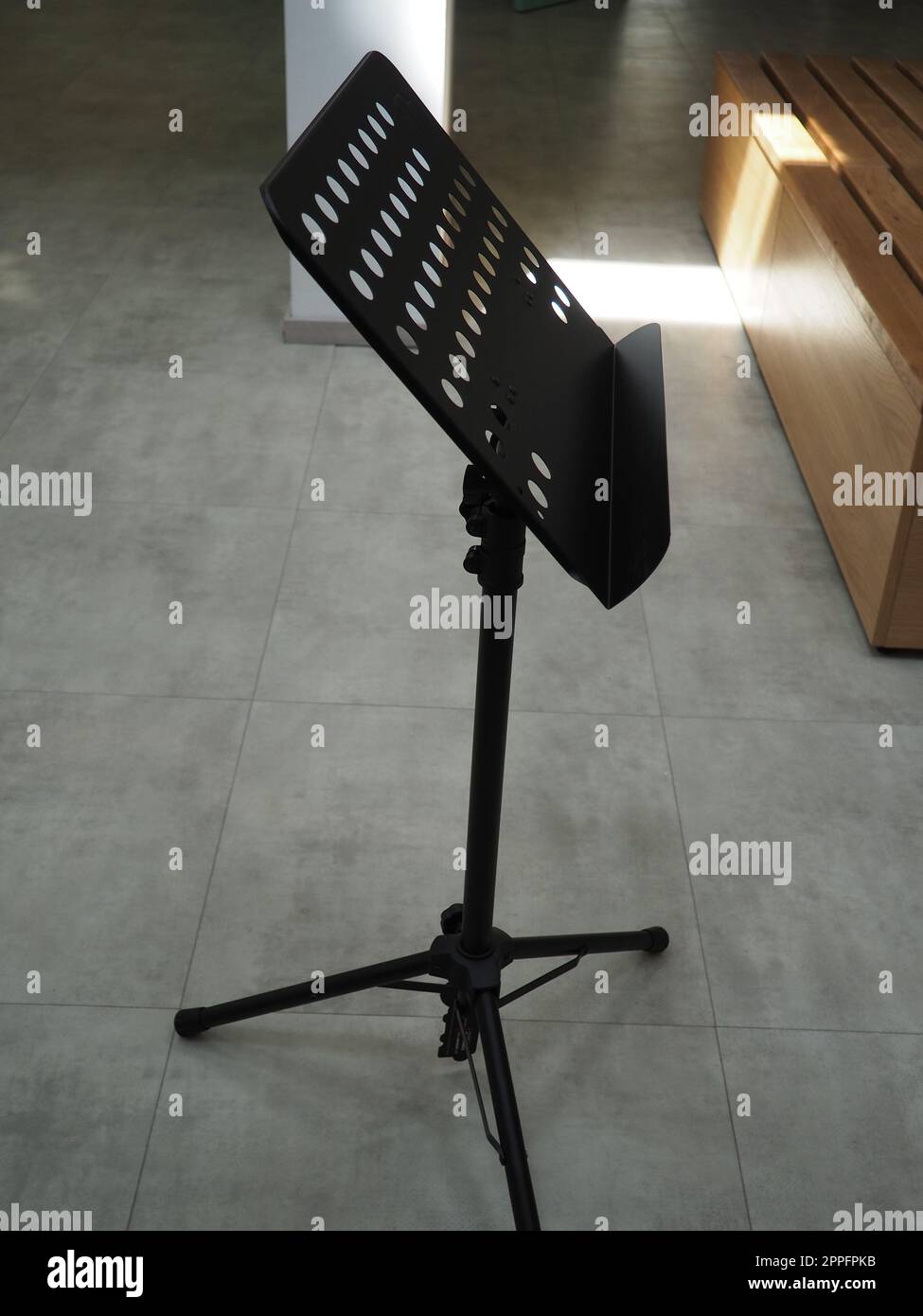 Music stand and bench, beam of light on the floor. A theater ...