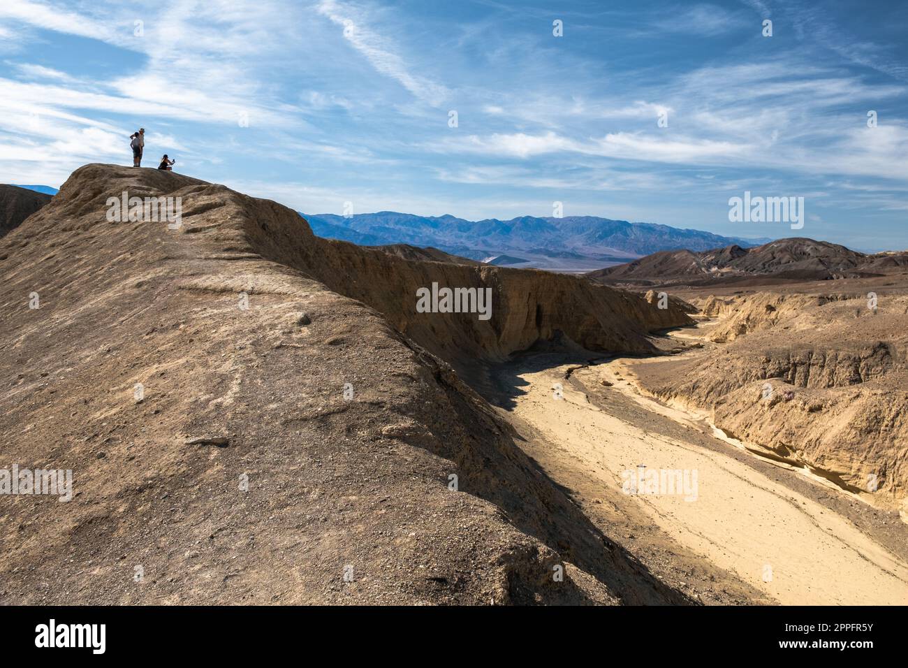 People watching from a cliff edge at Artist Point, Death Valley Stock ...