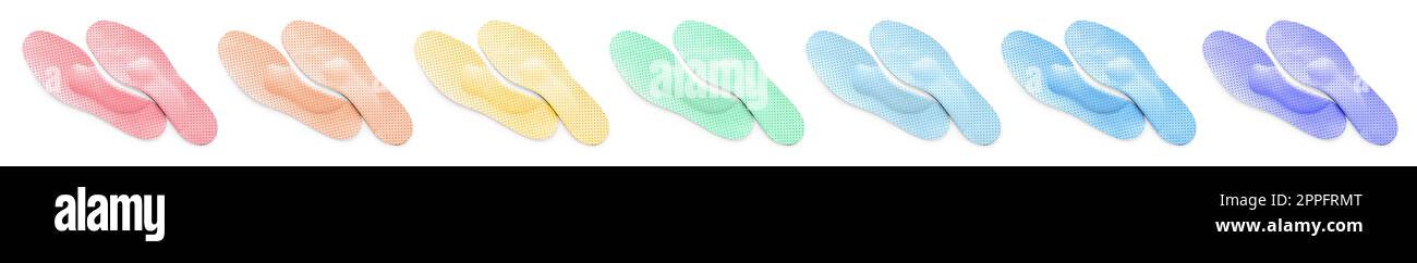Set with colorful orthopedic insoles on white background, top view ...