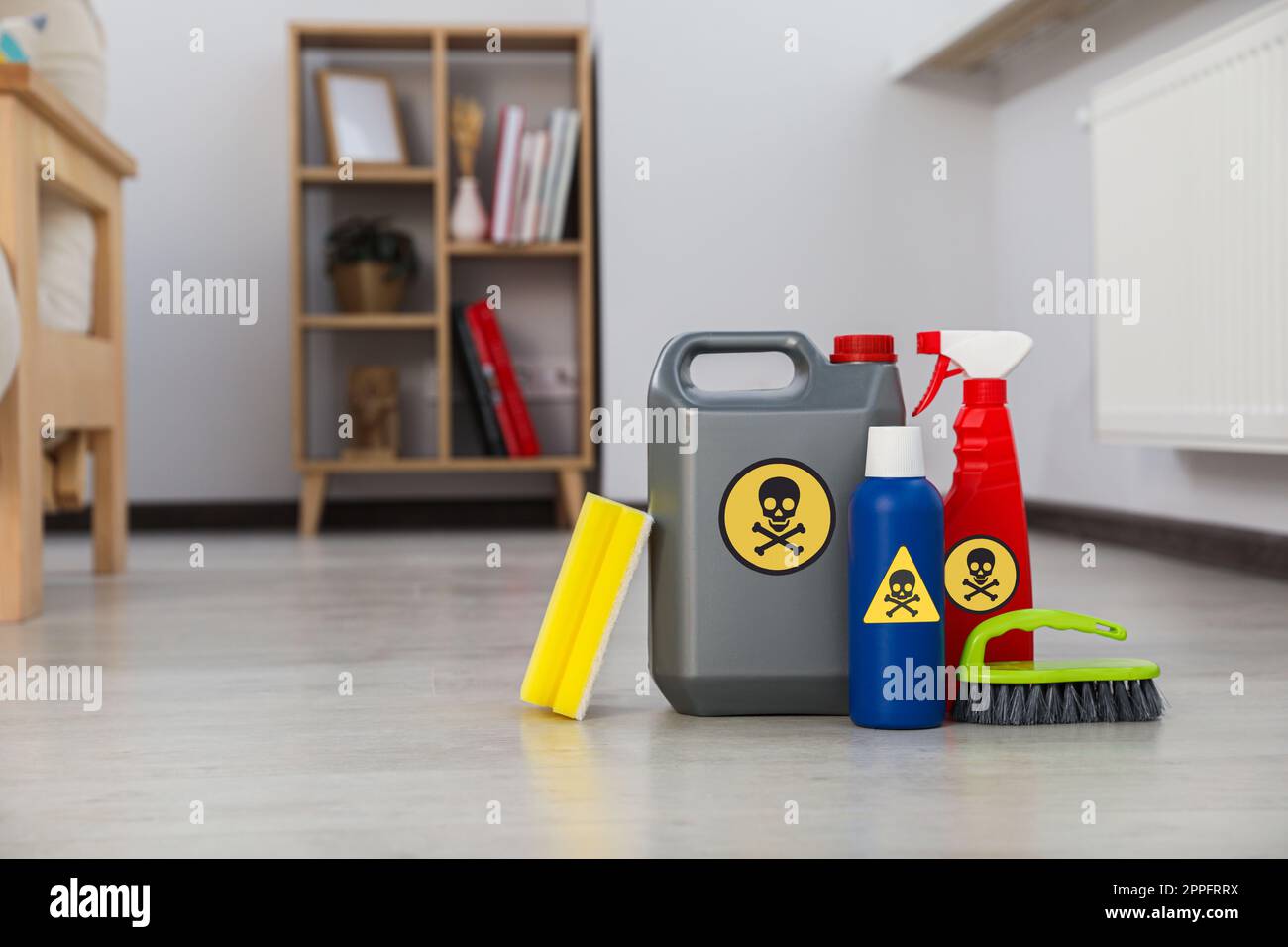 Bottles of toxic household chemicals with warning signs, brush and ...