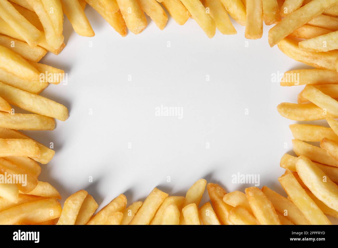 Frame of delicious french fries on white background, flat lay. Space ...