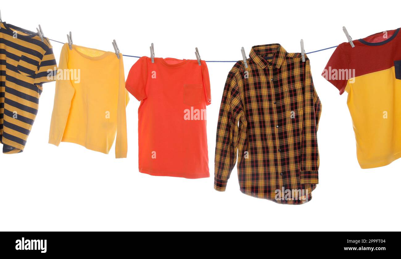 Different bright clothes drying on washing line against white ...