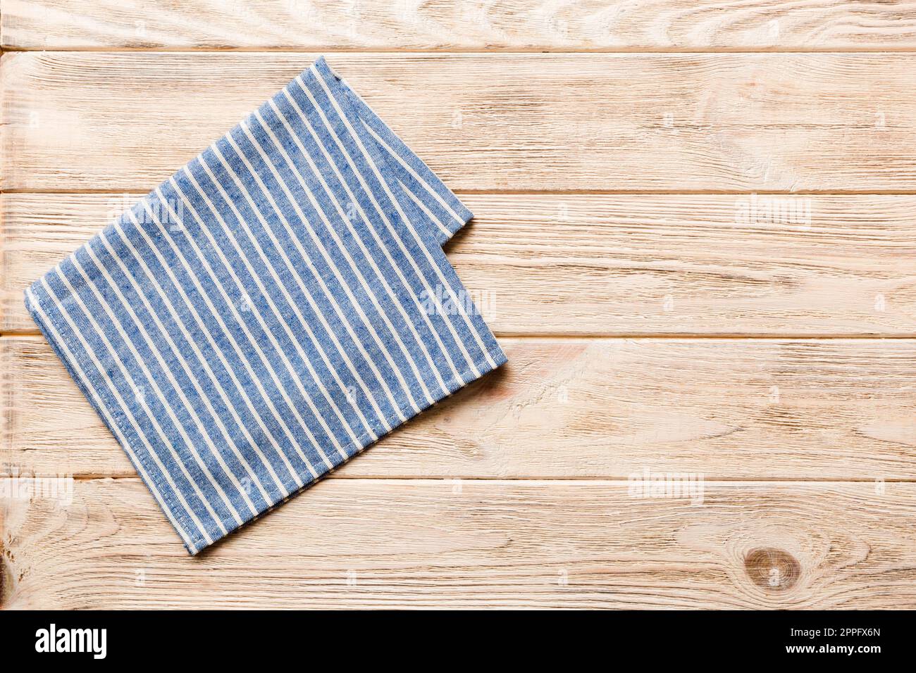 top view with blue kitchen napkin isolated on table background. Folded ...