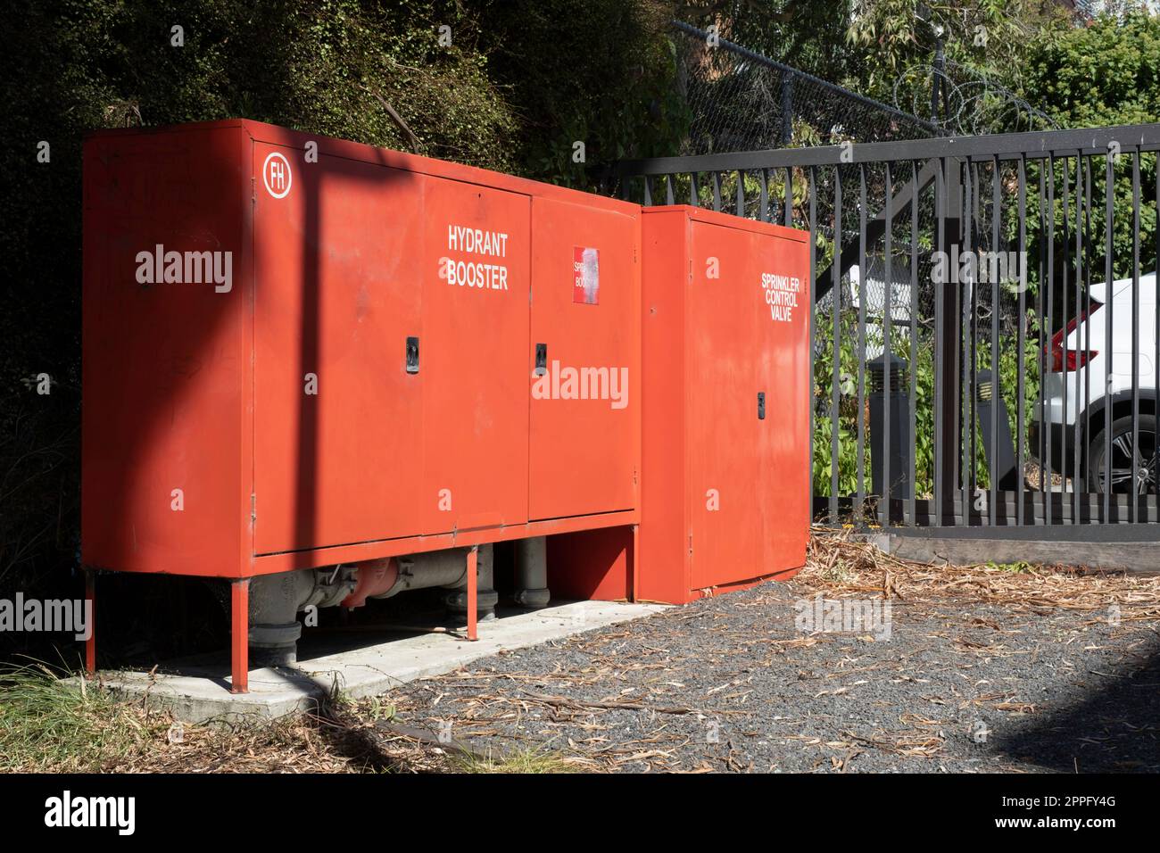 Red fire hydrant and sprinkler booster system in a metal box in a ...