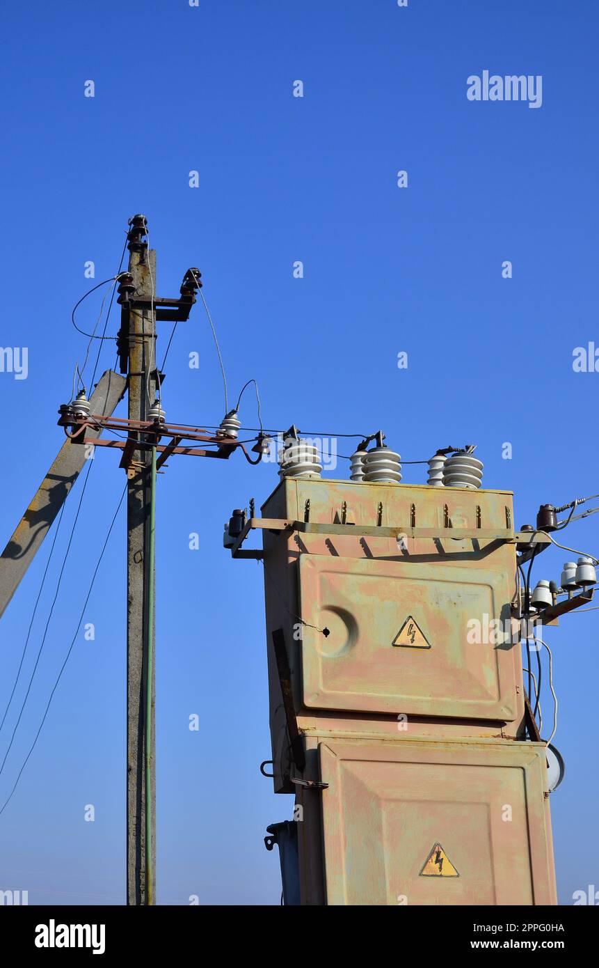 Old and obsolete electrical transformer against the background of a ...