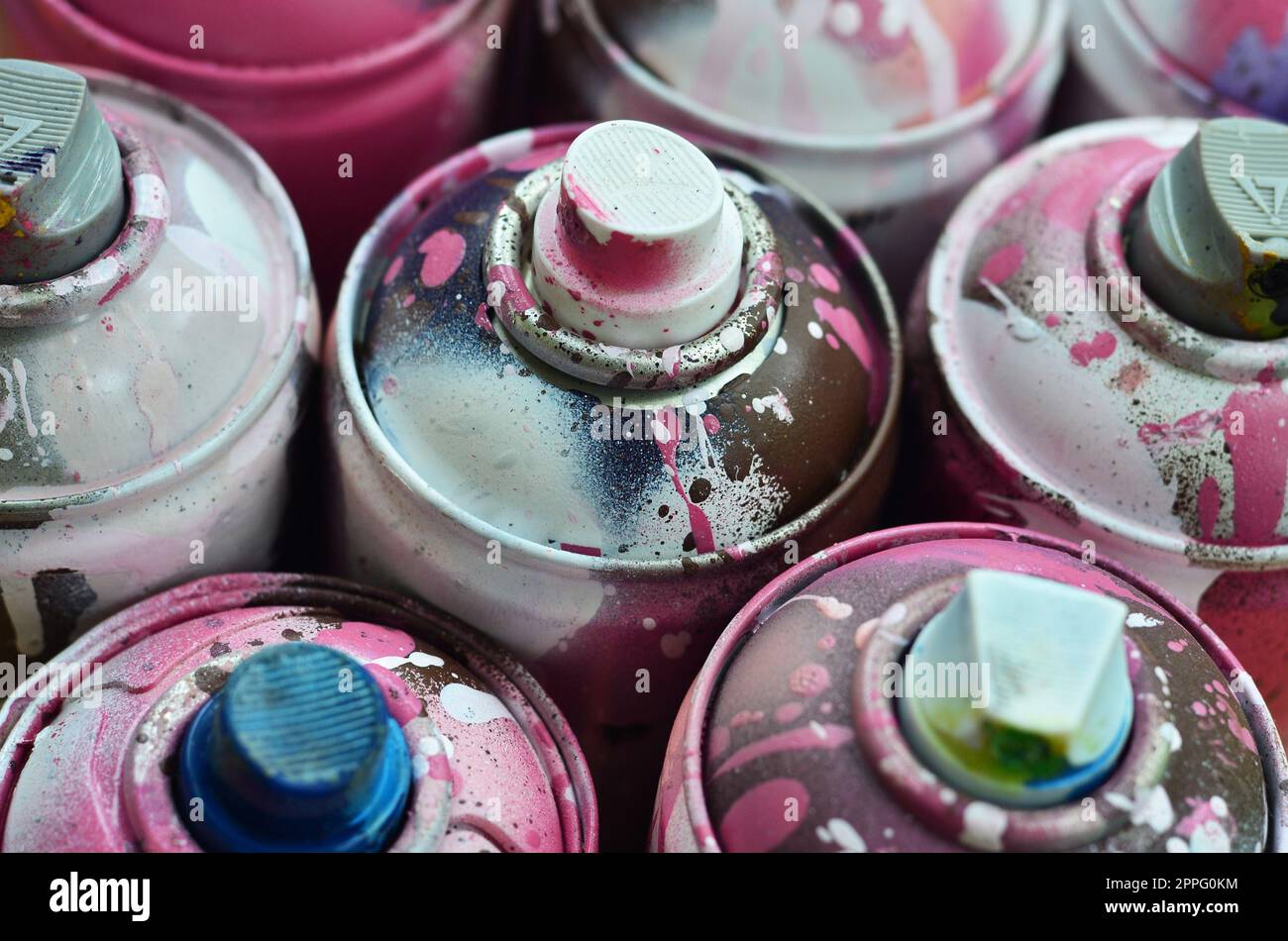 A lot of used spray cans of paint close-up. Dirty and smeared cans for ...