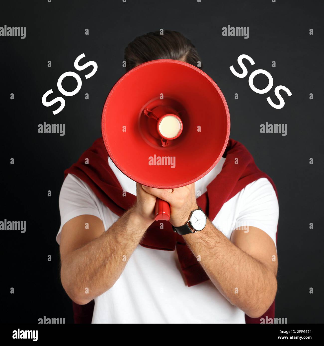 Man with red megaphone and words SOS on black background. Asking for ...