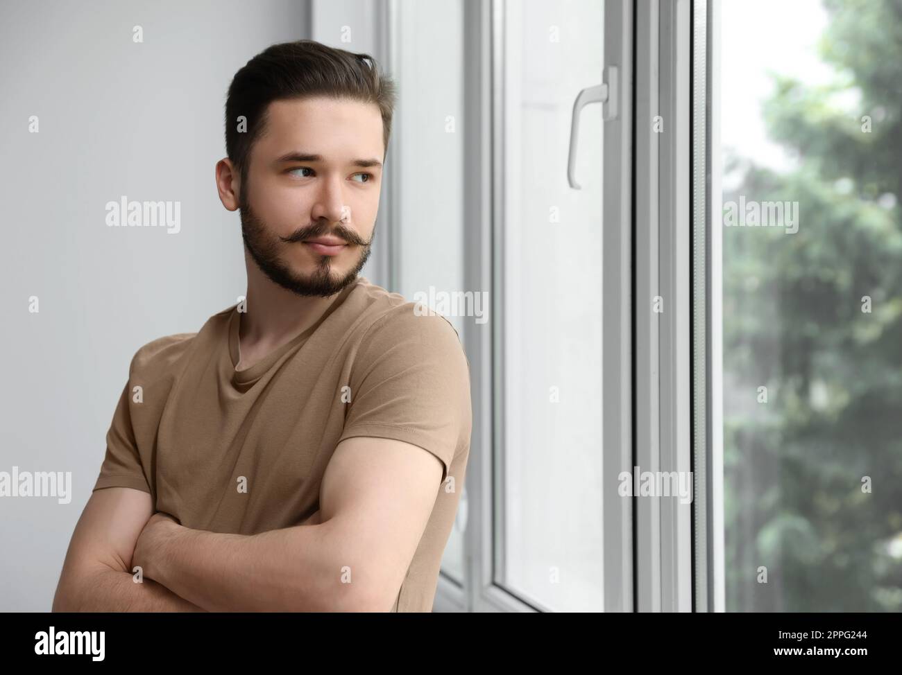 Handsome man near window indoors. Space for text Stock Photo - Alamy