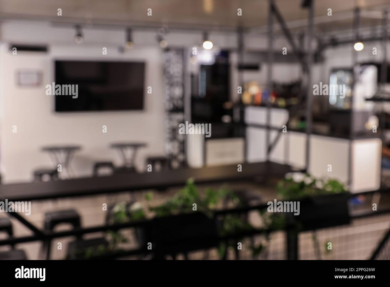 Blurred view of hostel dining room interior with comfortable furniture ...