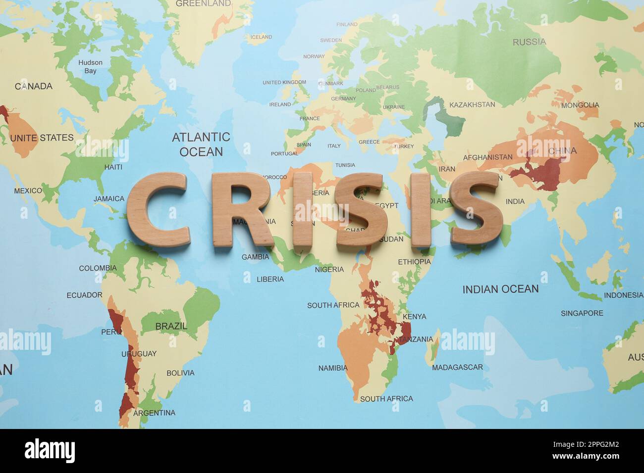 Word Crisis made of wooden letters on world map, flat lay Stock Photo ...