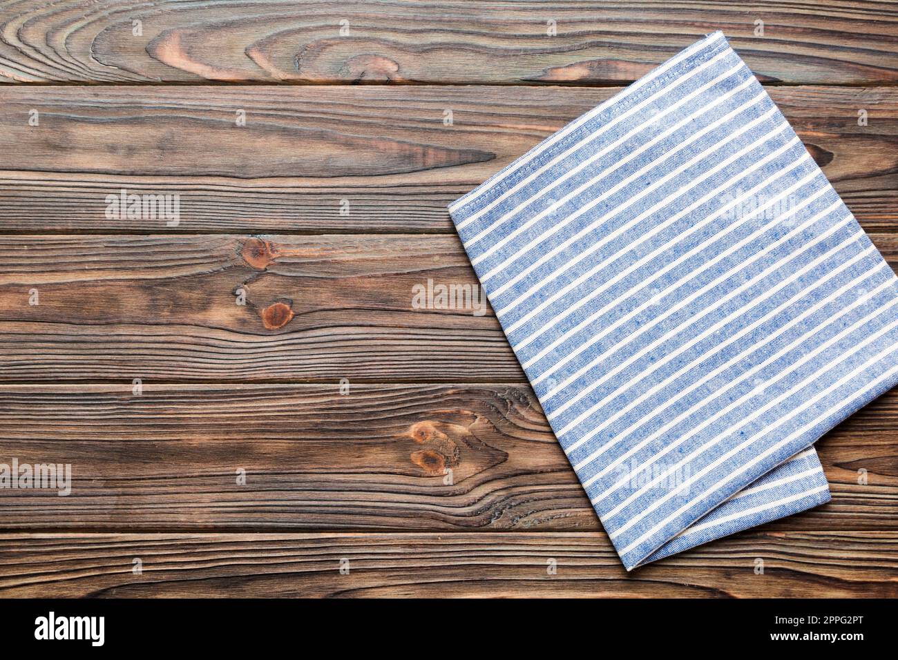 top view with blue kitchen napkin isolated on table background. Folded ...