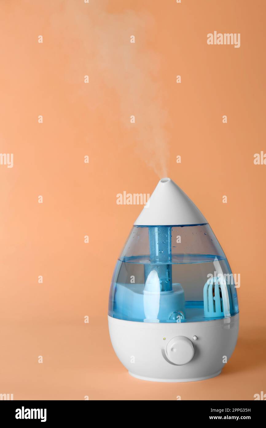 New modern air humidifier on orange background Stock Photo - Alamy