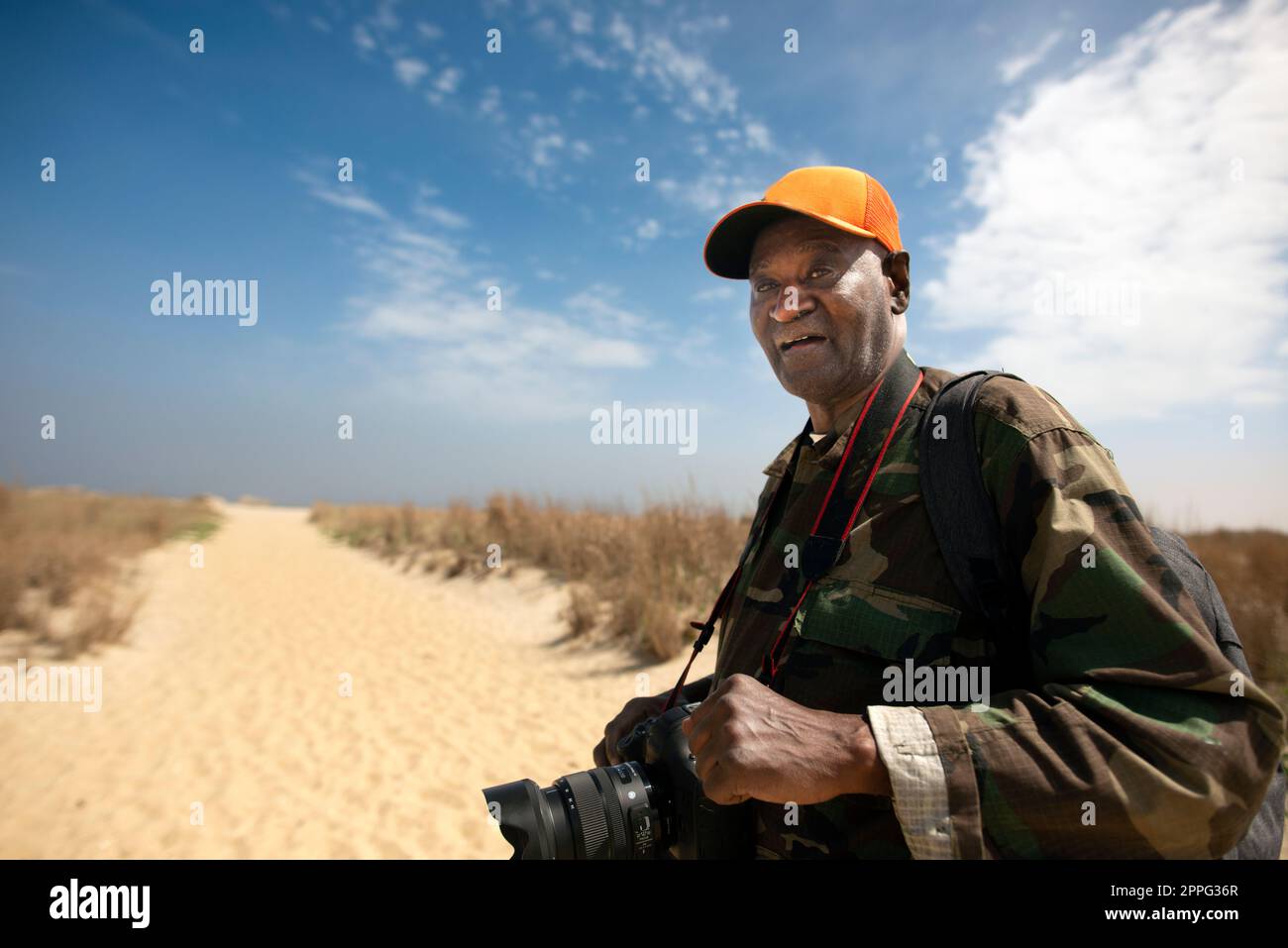 Senior retiree photographing nature at the beach Stock Photo - Alamy