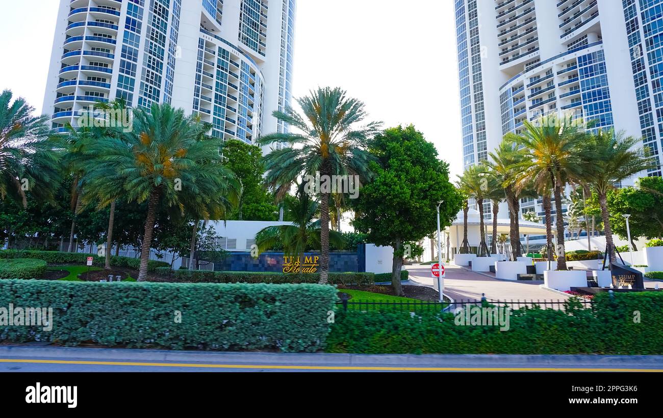 Modern apartment buildings with palm trees at Miami - view from road ...
