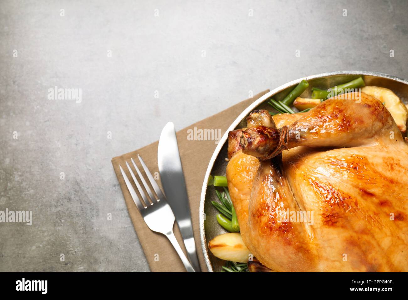 Delicious cooked turkey with garnish on grey table, top view with space ...