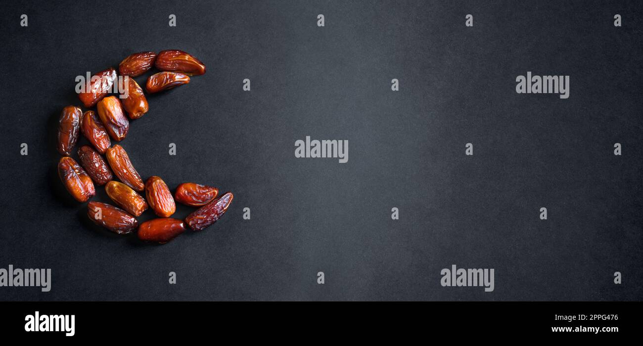 Ramadan Kareem with dates fruits arranged in shape of crescent moon on ...