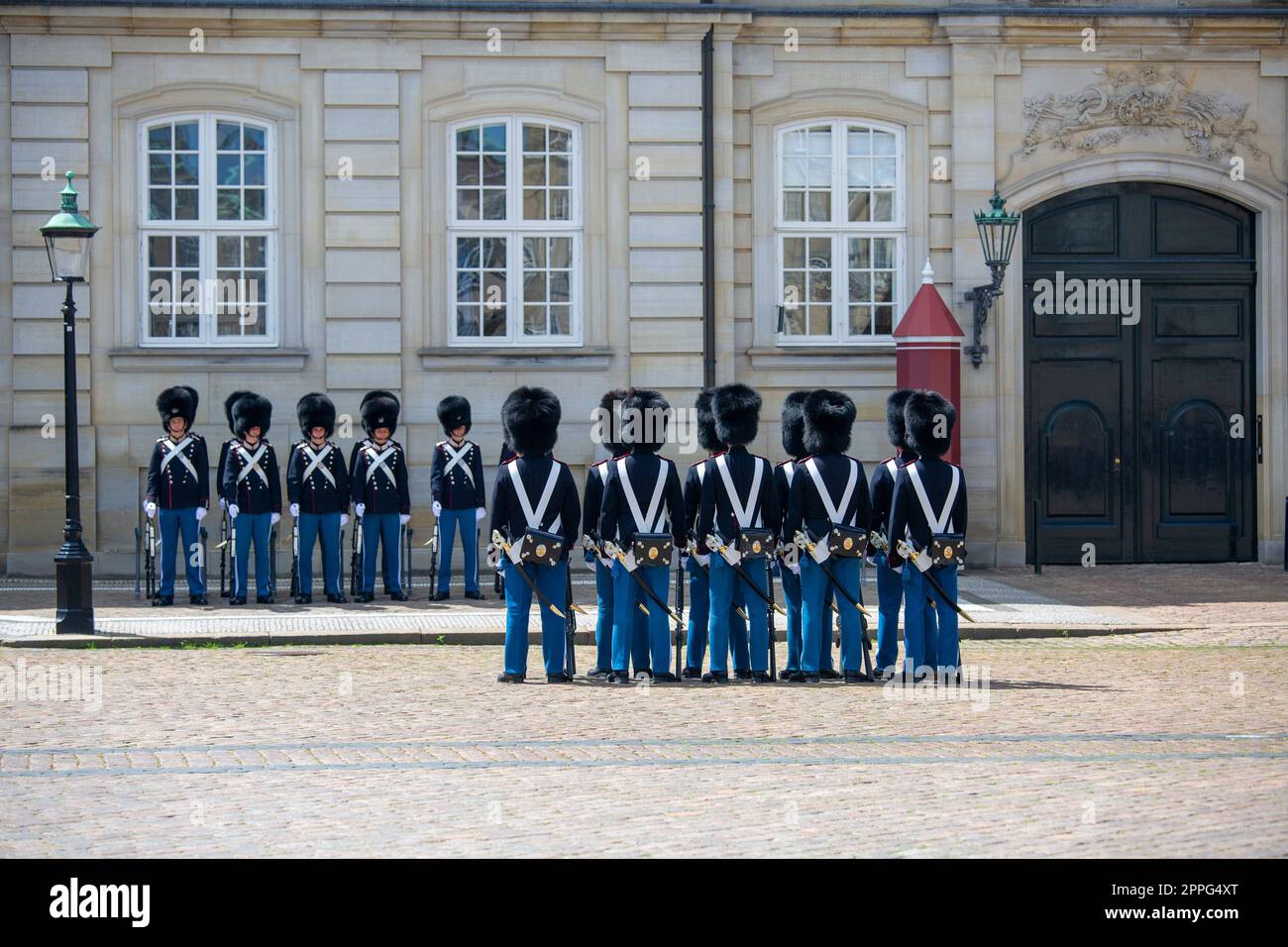 Changing of the guard in the courtyard in front of the Amalienborg palace, Copenhagen, Denmark ...