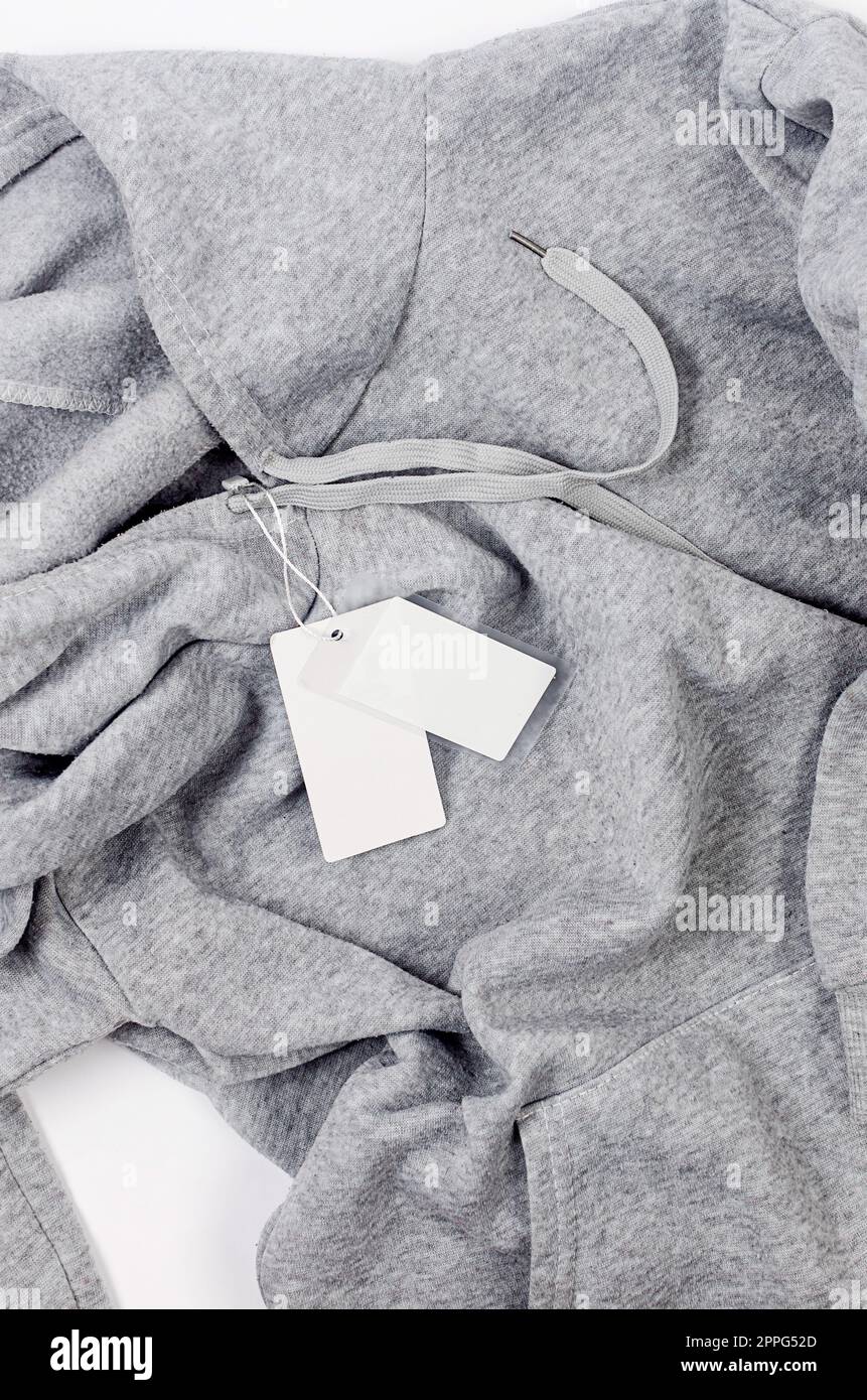 Empty white cardboard tag with string ongrey jersey hoodie. label blank ...