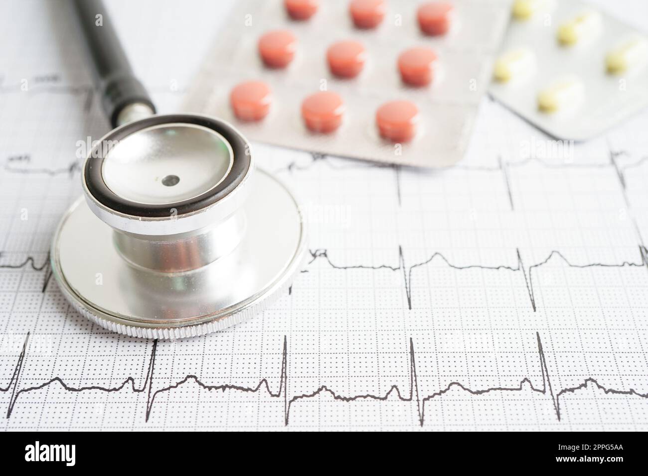 Stethoscope on electrocardiogram (ECG) with drug, heart wave, heart ...