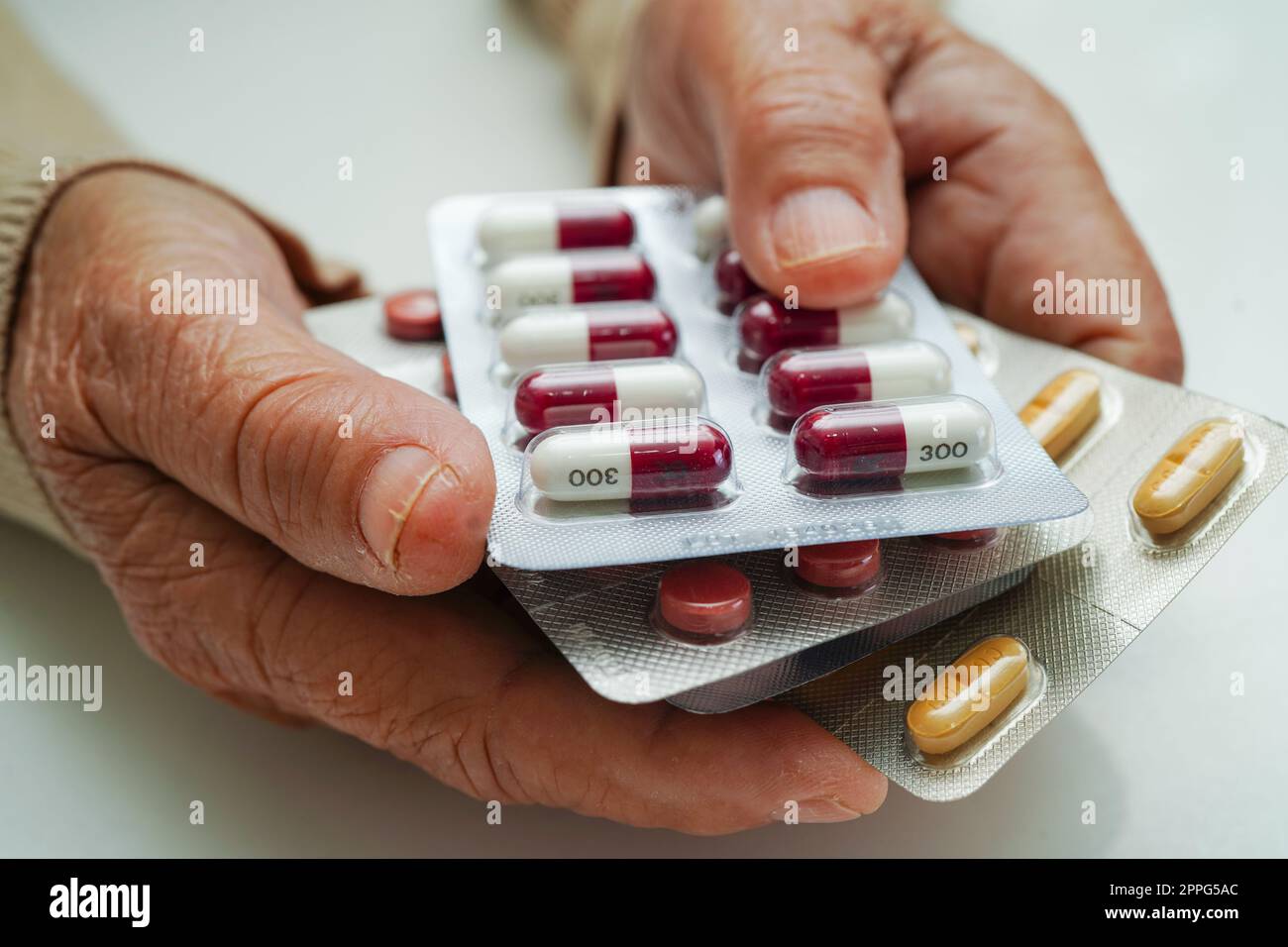 Asian elderly woman holding pill drug in hand, strong healthy medical ...
