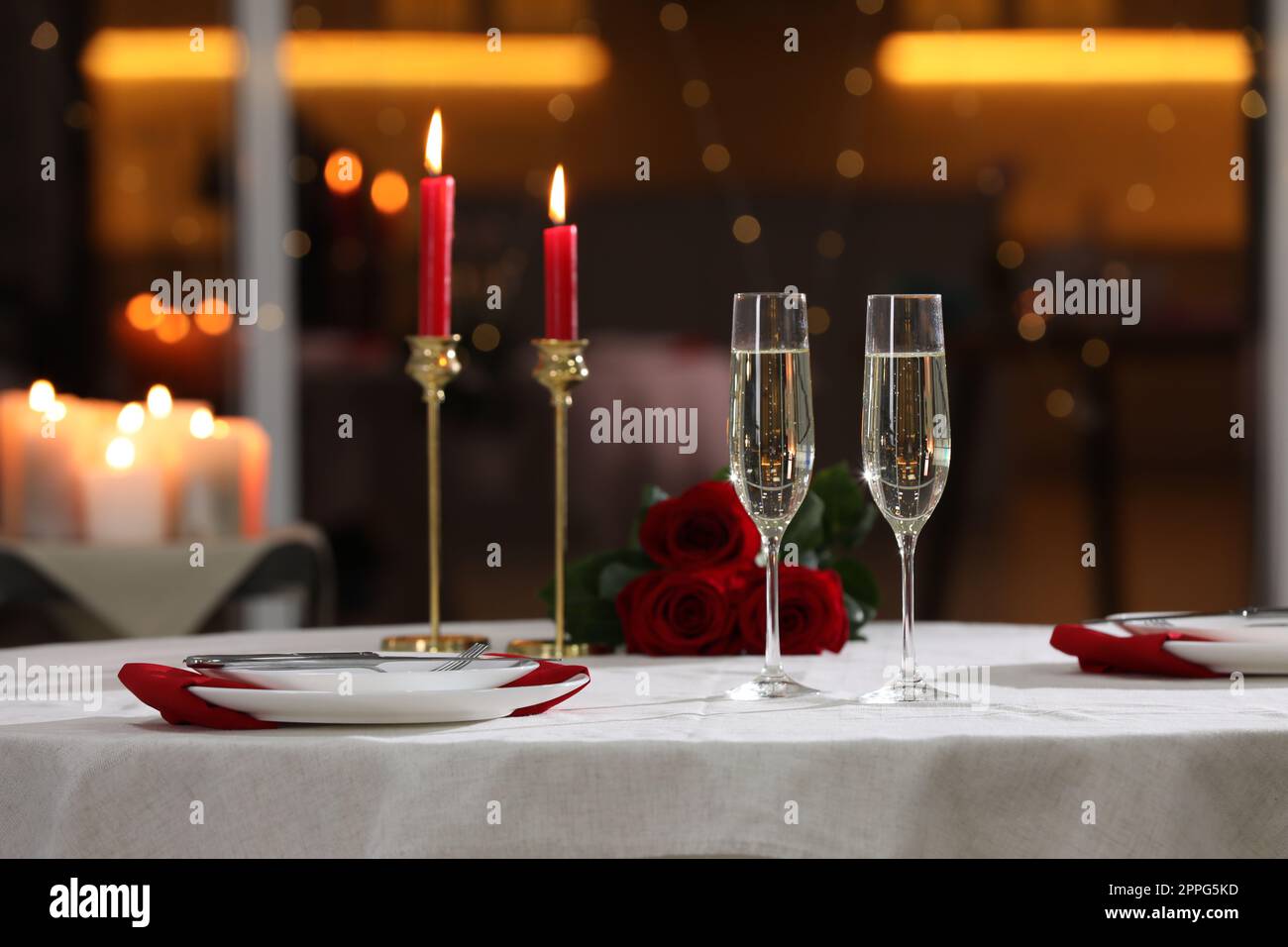 Romantic dinner table setting with glasses of champagne in restaurant ...