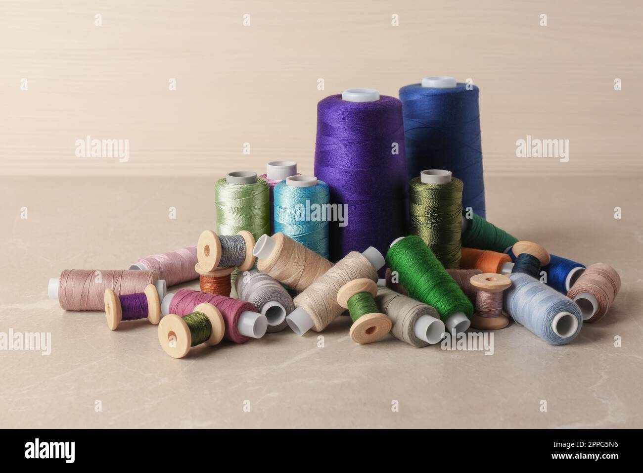 Set of color sewing threads on light grey table Stock Photo - Alamy