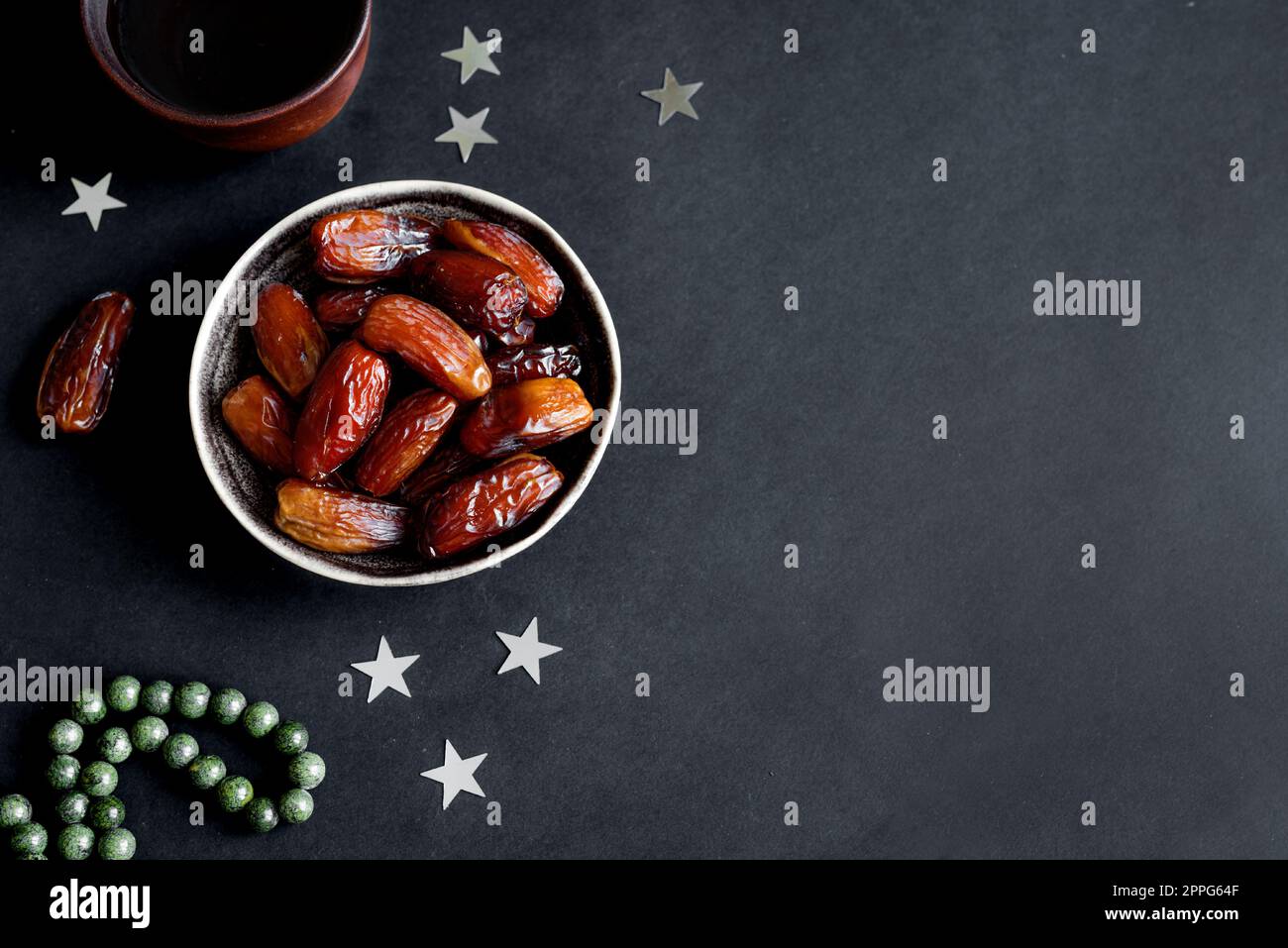 Ramadan iftar food - date fruits and arabic coffee on black, top view ...
