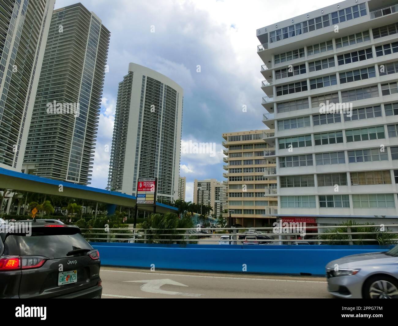Modern apartment buildings with palm trees at Miami - view from road ...