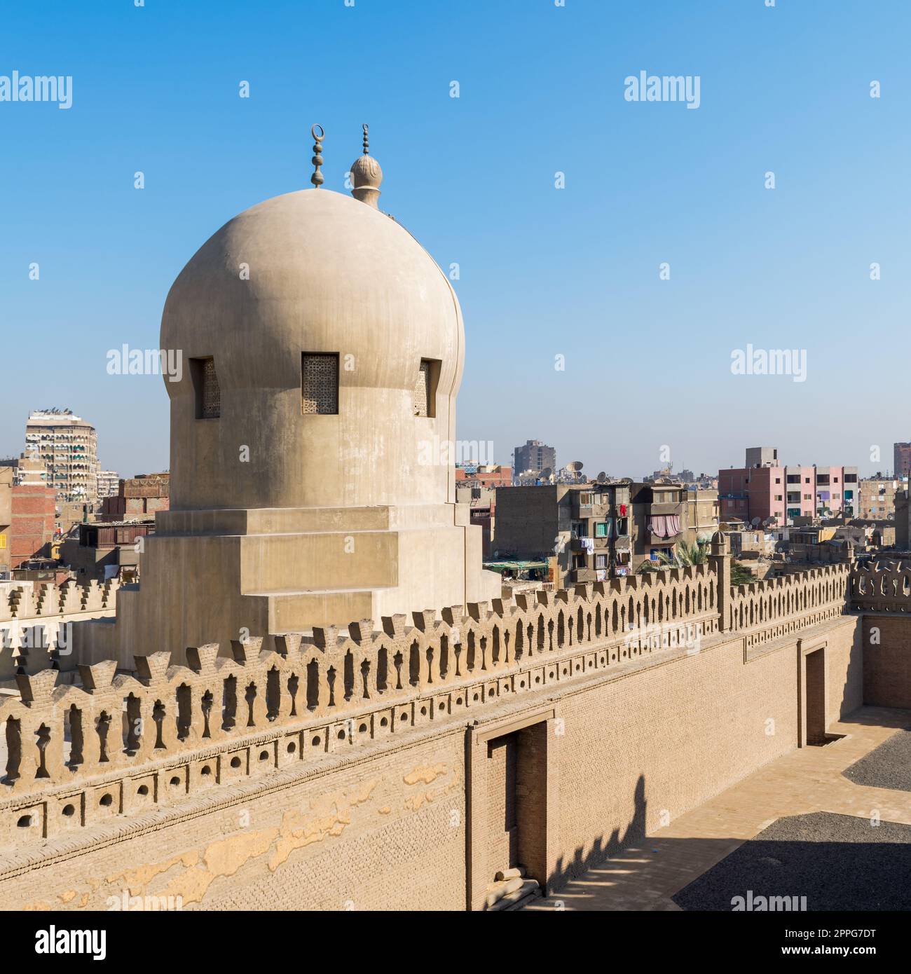 Fence of Ibn Tulun Mosque revealing dome of Amir Sarghatmish mosque ...