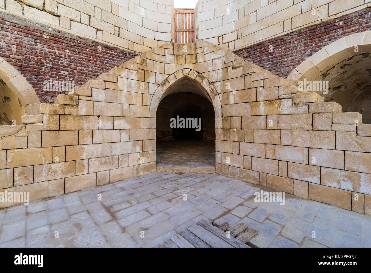 Ancient brick building with two shabby stone stairways, picket gate and ...