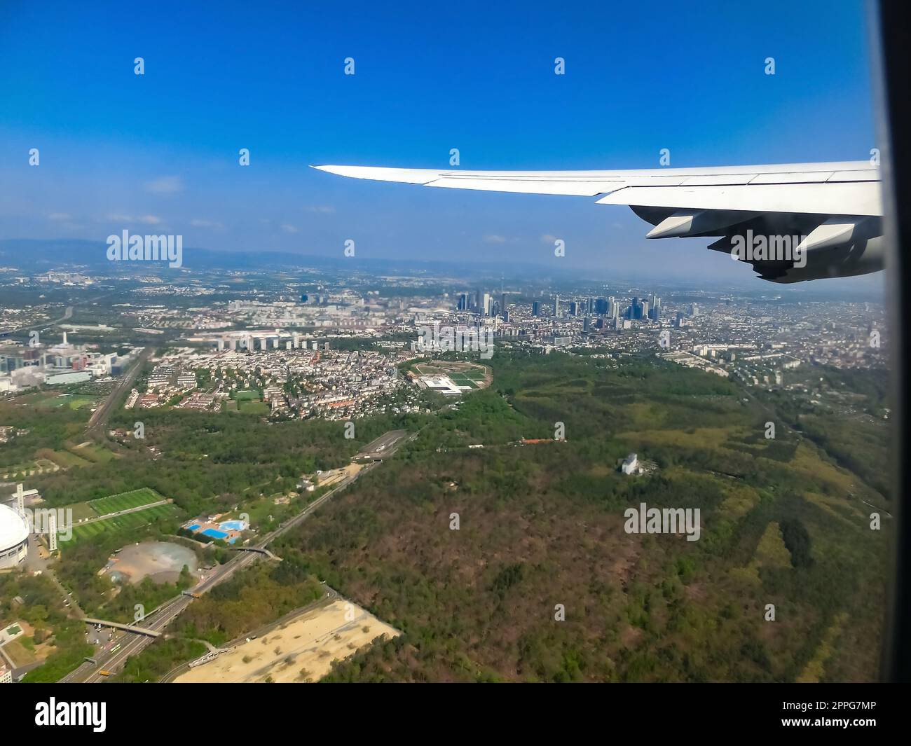 Airplane window view of wing, highway junctions and green forest Stock ...