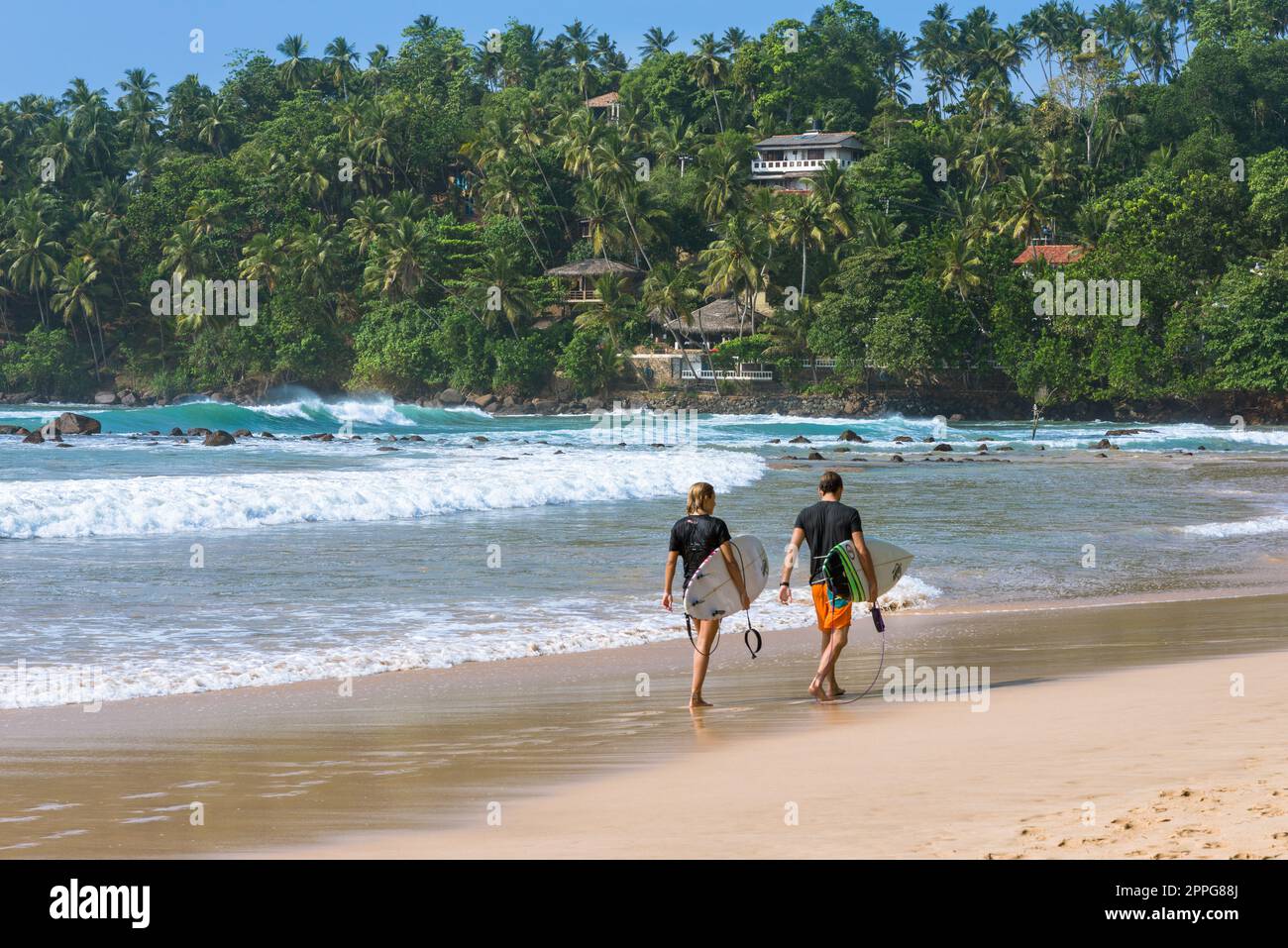 The beach and bay of the coastal village and tourist resort Mirissa in ...