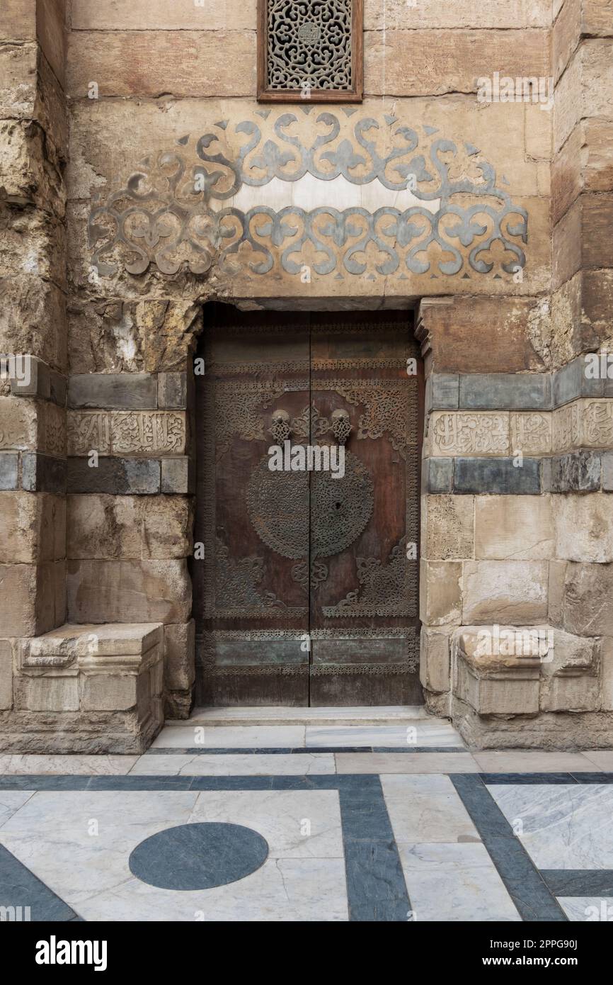 Stone bricks wall and wooden decorated copper plated door at Sultan ...