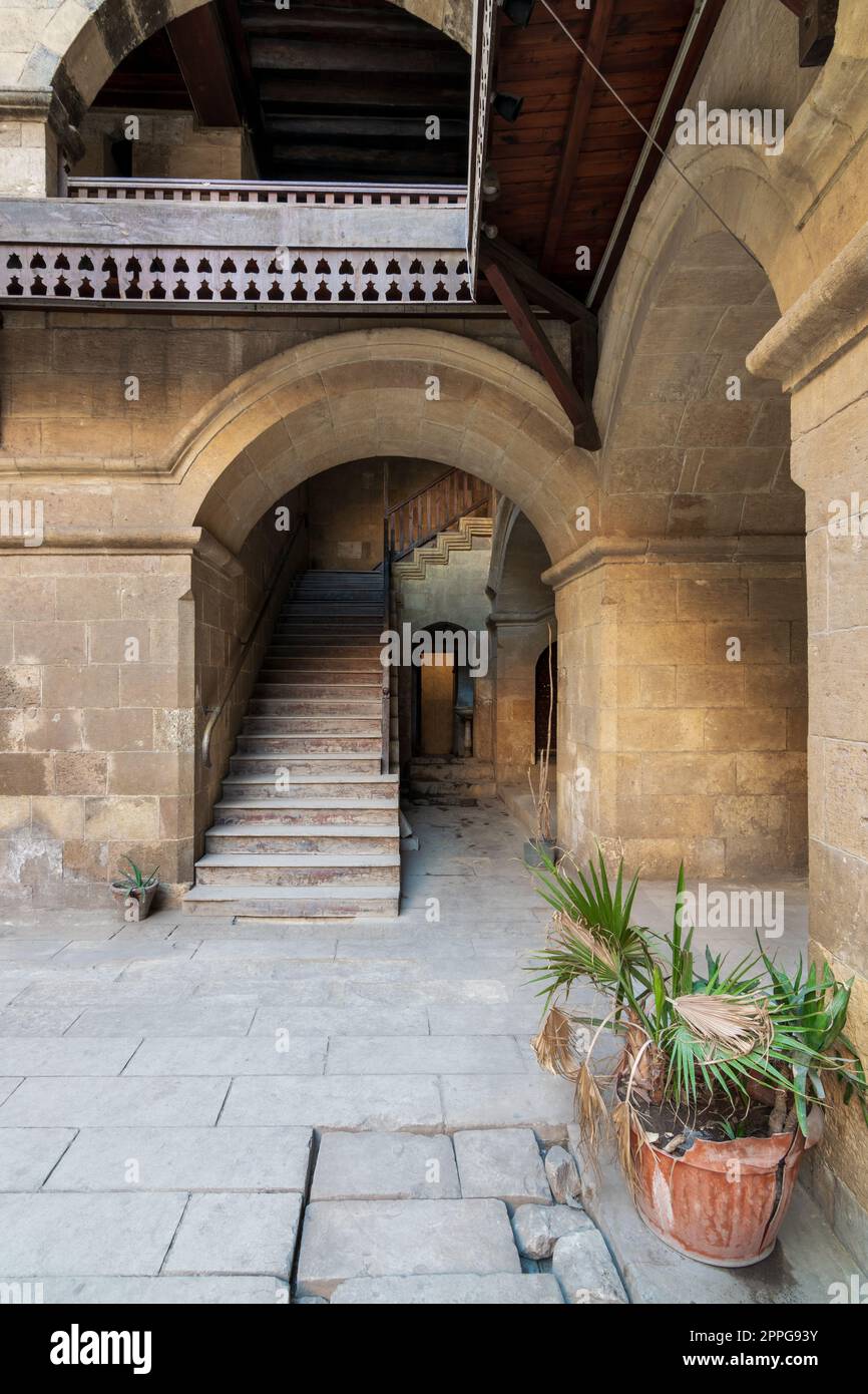 Staircase with wooden balustrade leading to an old abandoned historic ...