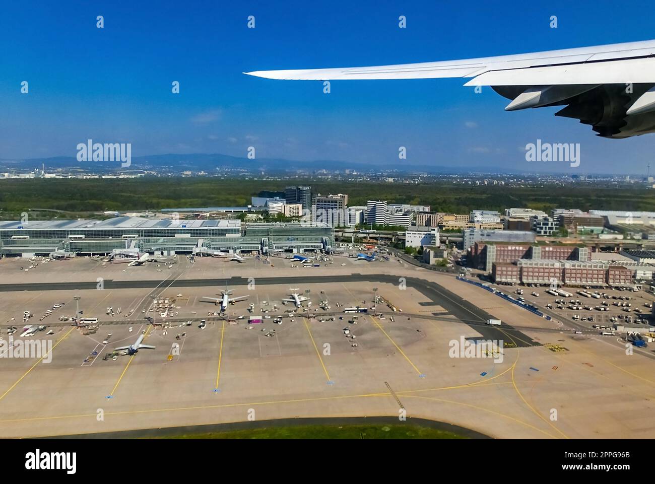 Airplane window view of wing, highway junctions and green forest Stock ...