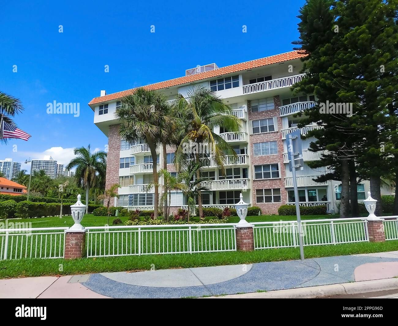 Modern apartment buildings with palm trees at Miami - view from road ...
