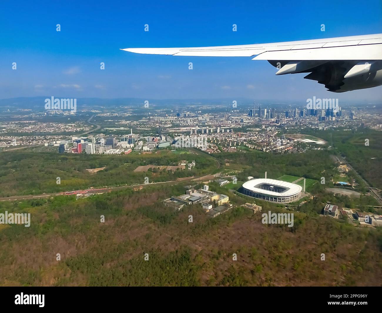 Airplane window view of wing, highway junctions and green forest Stock ...